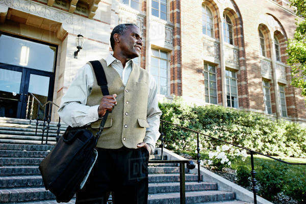 African American professor walking on campus - Stock Photo - Dissolve