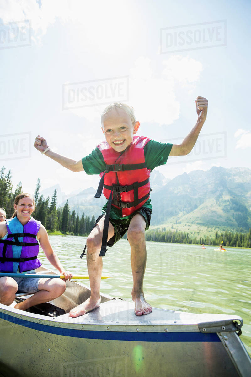 Caucasian boy standing on canoe on lake - Royalty-free Stock Photo ...