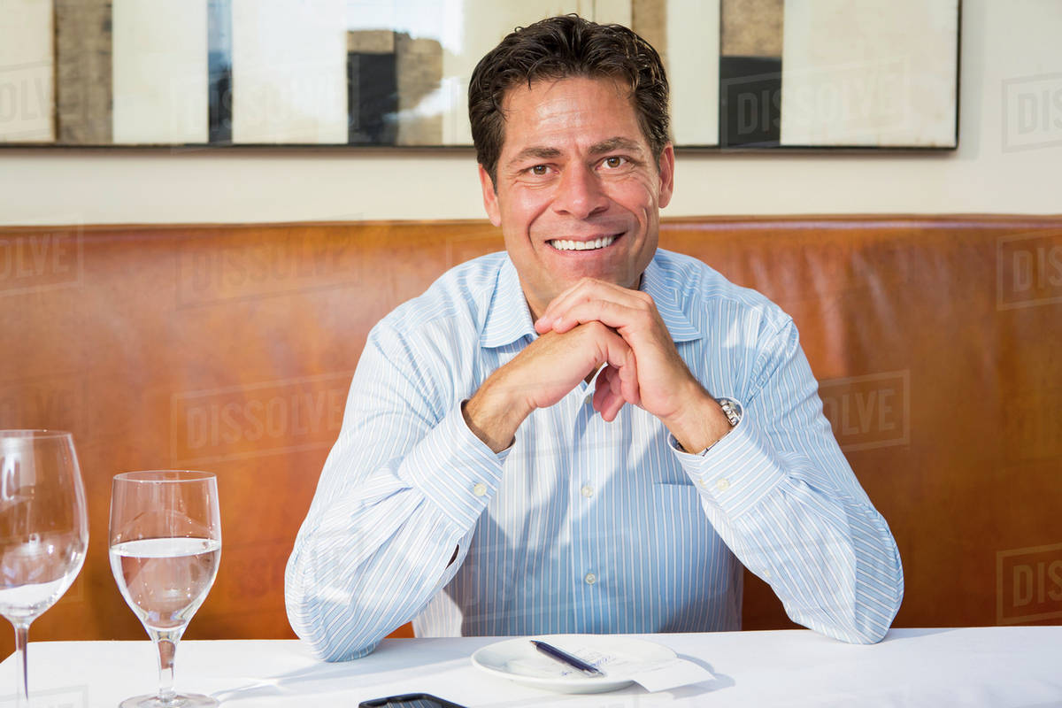 Caucasian businessman working at restaurant - Stock Photo - Dissolve