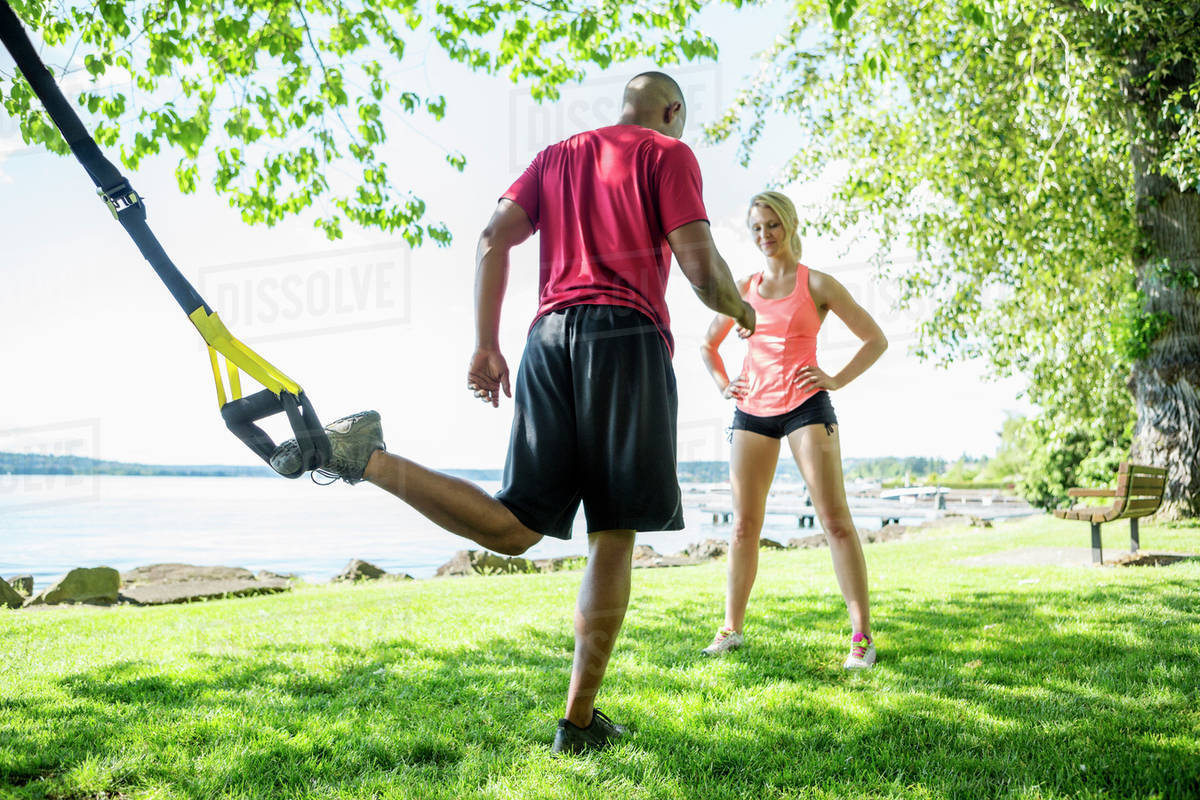Caucasian man working with trainer outdoors - Stock Photo - Dissolve
