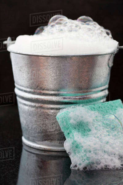 Bucket of soap suds and sponge - Stock Photo - Dissolve