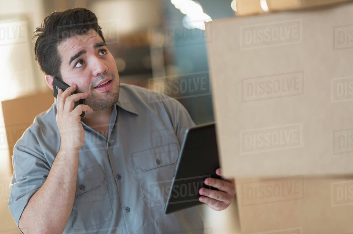 Mixed race worker counting boxes in warehouse - Royalty-free Stock ...