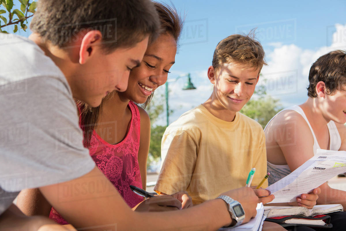 Teenagers doing homework together outdoors - Royalty-free Stock Photo ...