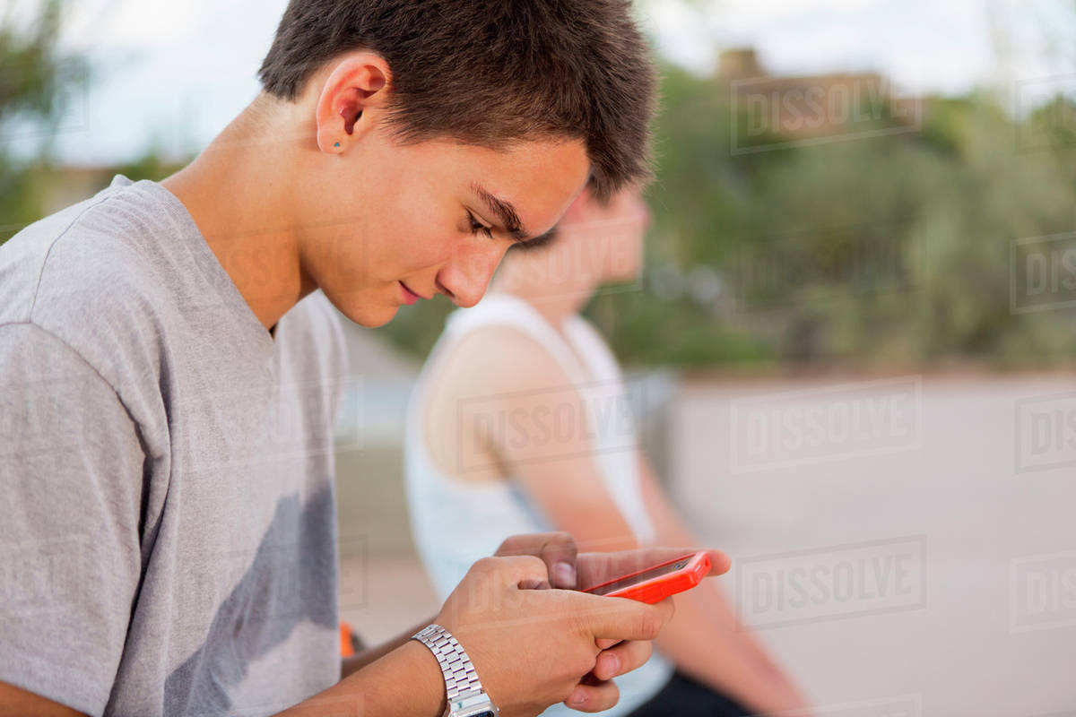 Caucasian boy using cell phone outdoors - Royalty-free Stock Photo ...