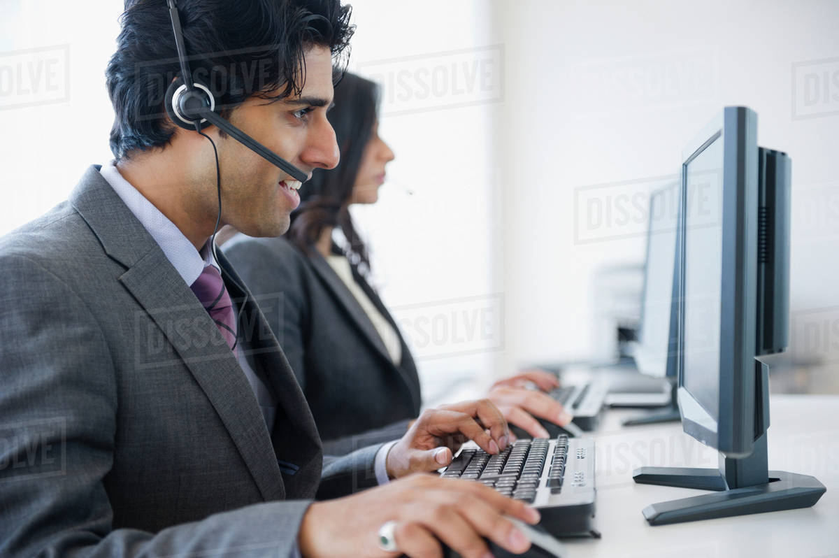 Mixed race business people using computers - Royalty-free Stock Photo ...