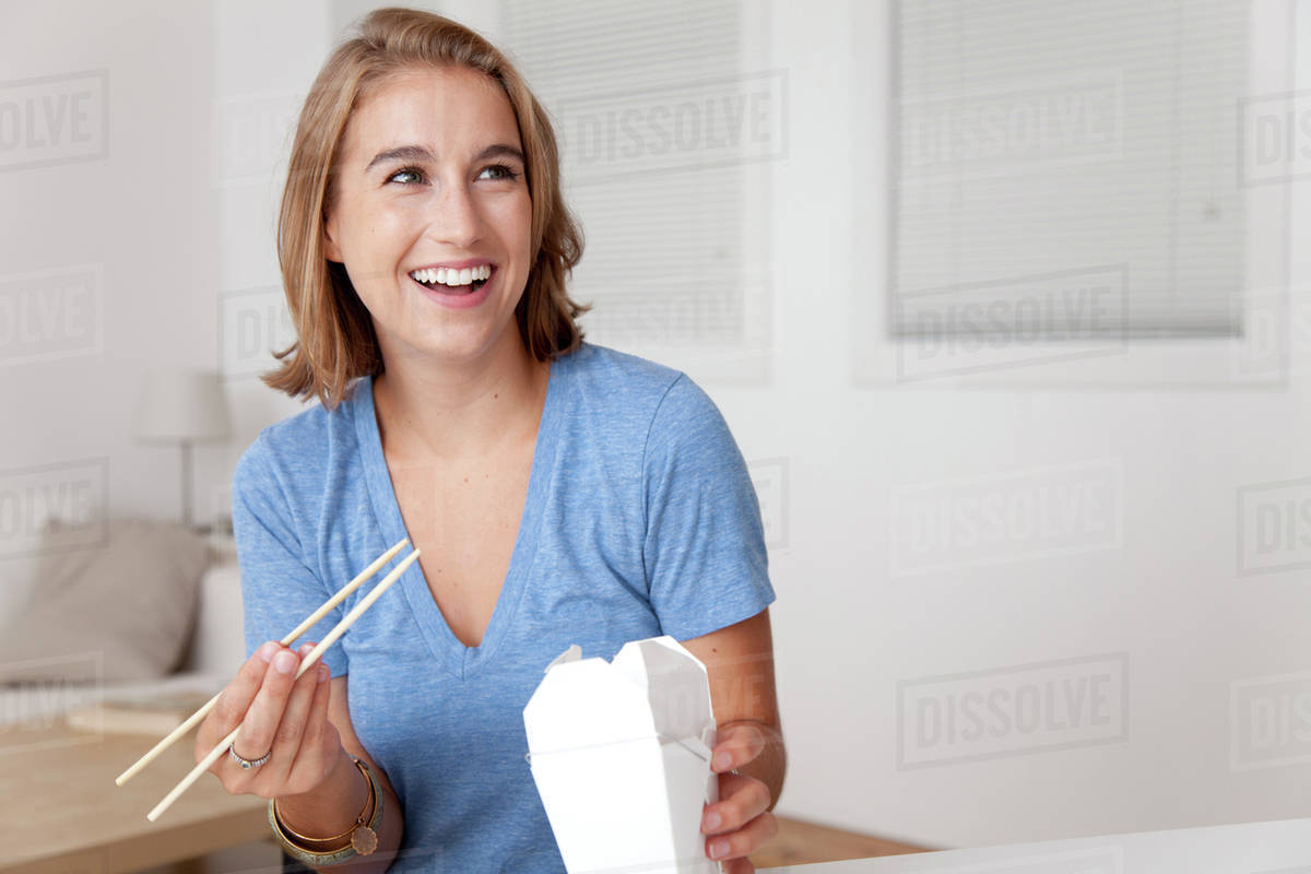 Caucasian woman eating Chinese food - Royalty-free Stock Photo | Dissolve