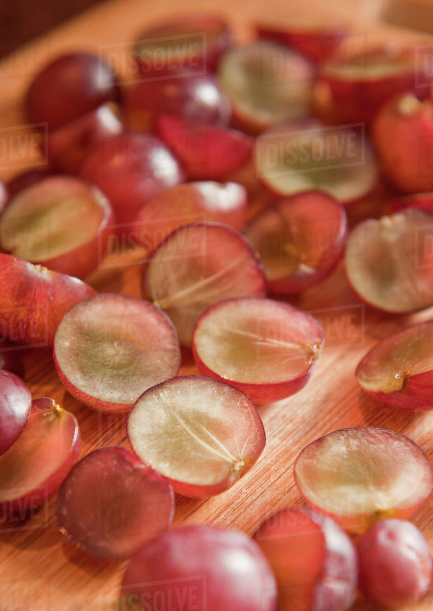 Sliced grapes on wooden board - Royalty-free Stock Photo | Dissolve