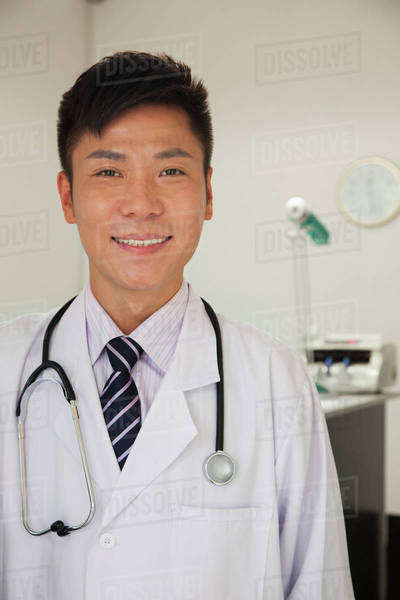 Chinese doctor smiling in hospital - Stock Photo - Dissolve