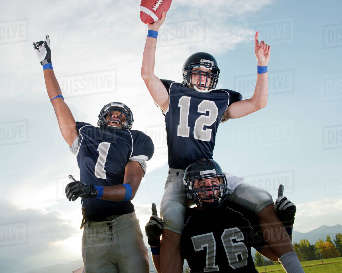 Football players cheering in game - Royalty-free Stock Photo | Dissolve