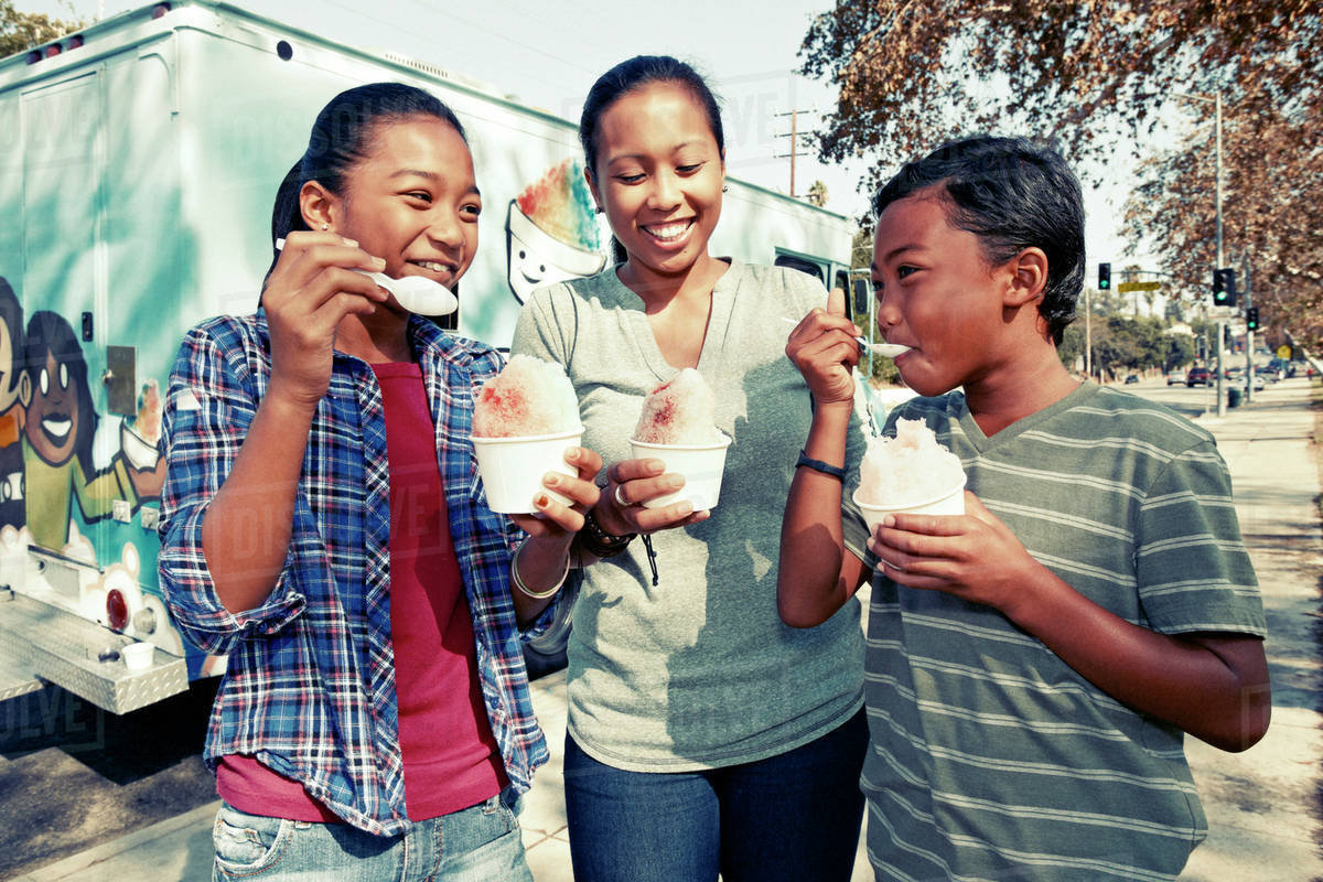 Family eating ice cream from truck - Royalty-free Stock Photo | Dissolve