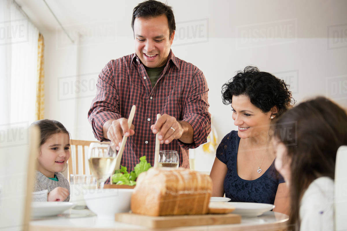 Family eating together at table - Royalty-free Stock Photo | Dissolve