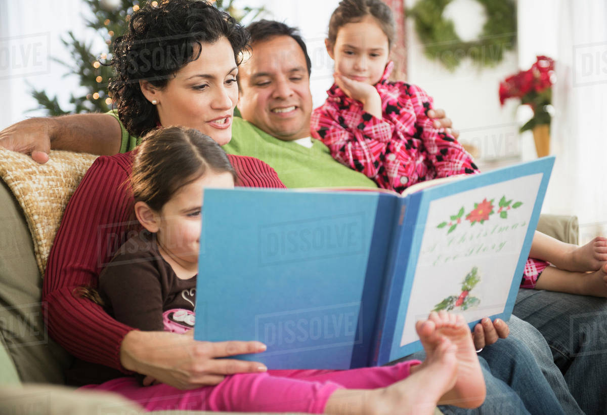 Family reading together on sofa - Royalty-free Stock Photo | Dissolve