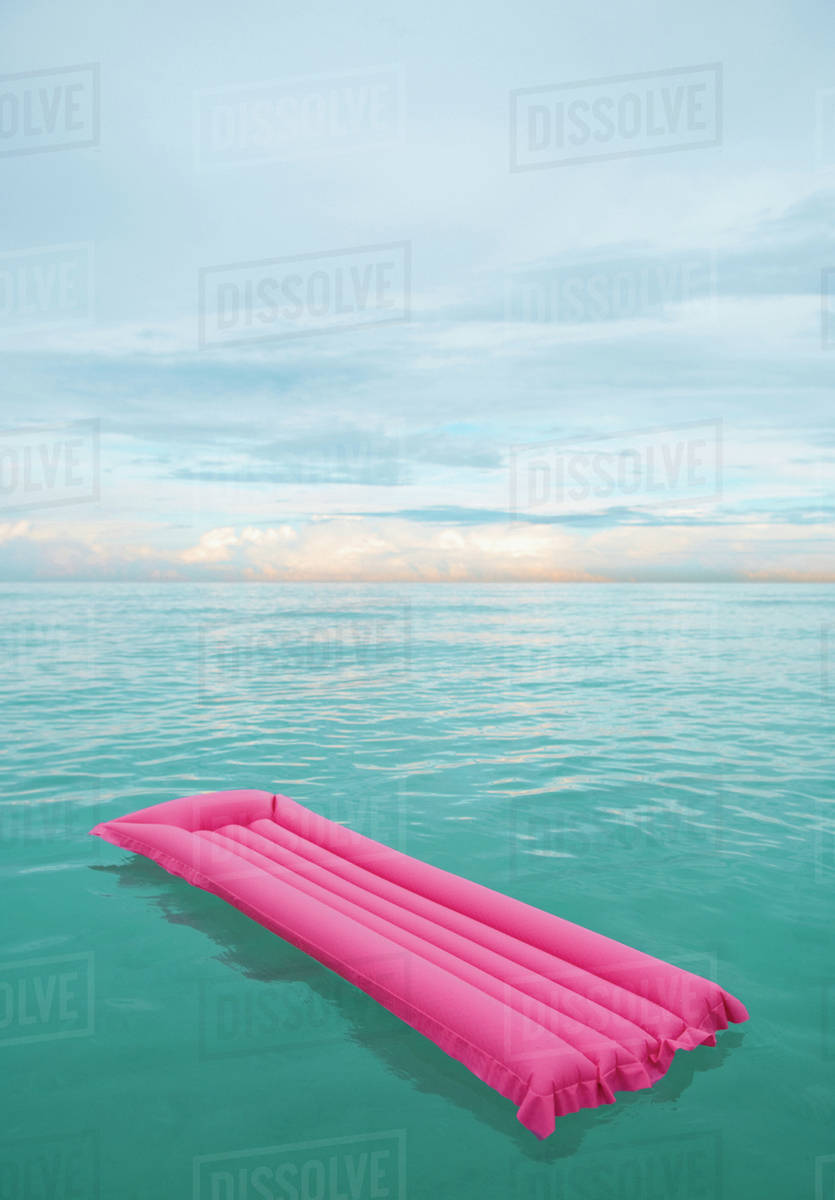 Inflatable raft floating in tropical water - Stock Photo - Dissolve