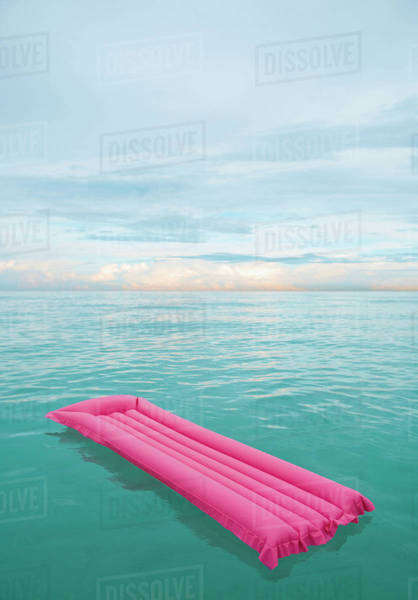 Inflatable raft floating in tropical water - Stock Photo - Dissolve