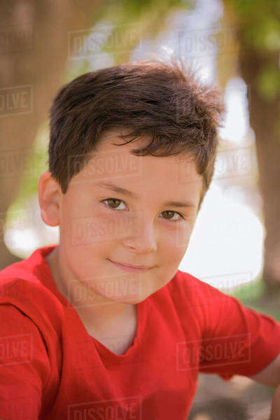 Hispanic boy smiling outdoors - Royalty-free Stock Photo | Dissolve