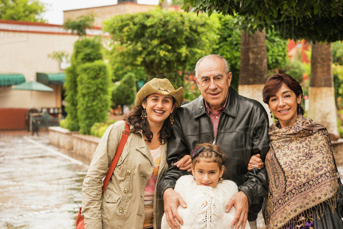 Family smiling together outdoors - Royalty-free Stock Photo | Dissolve