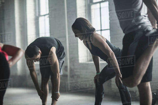 Athletes stretching legs in gym - Stock Photo - Dissolve