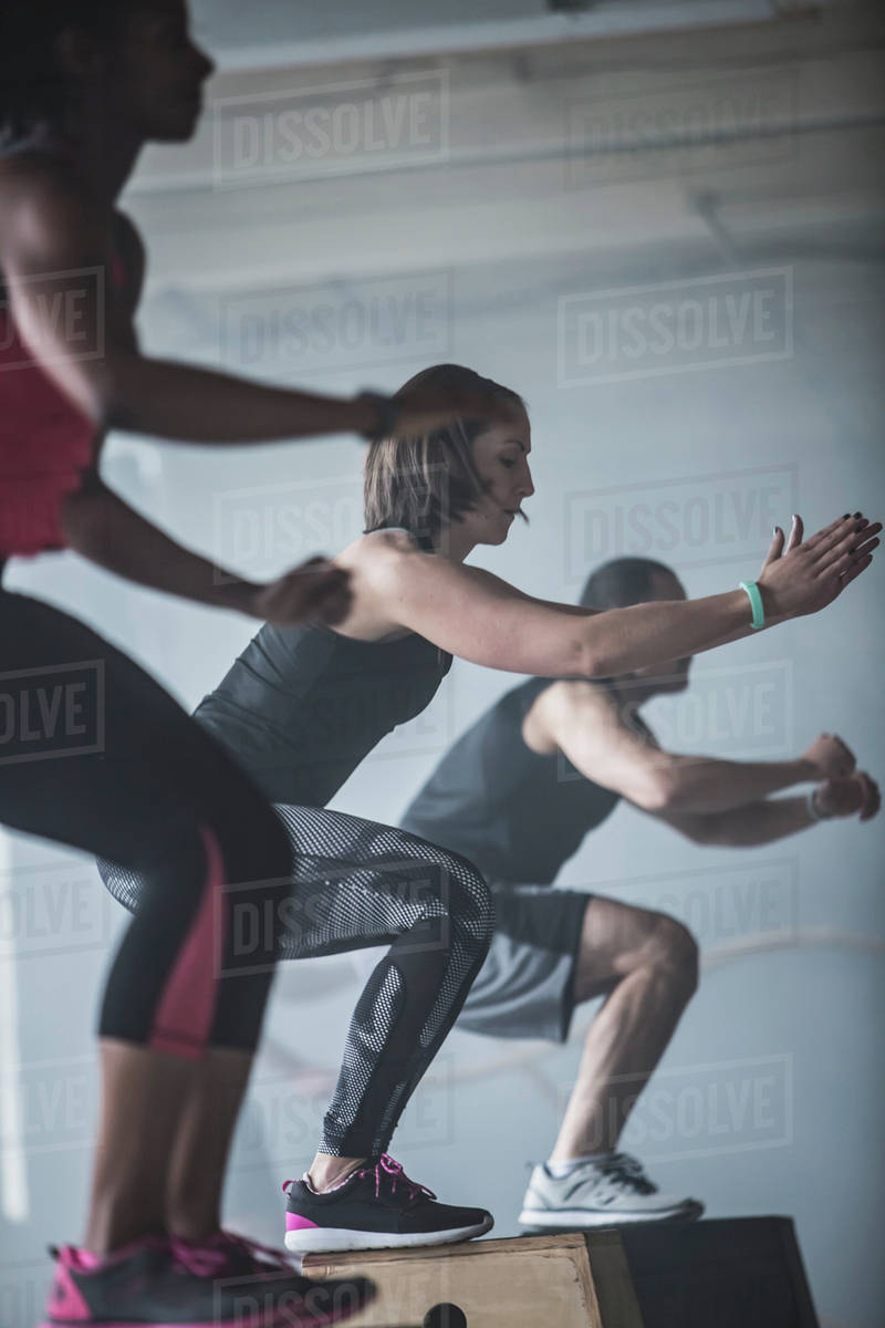 Athletes jumping on platforms in gym - Royalty-free Stock Photo | Dissolve