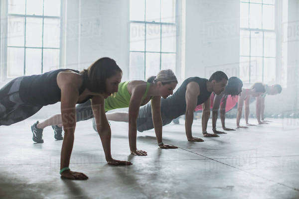 Athletes doing push-ups in gym - Royalty-free Stock Photo | Dissolve