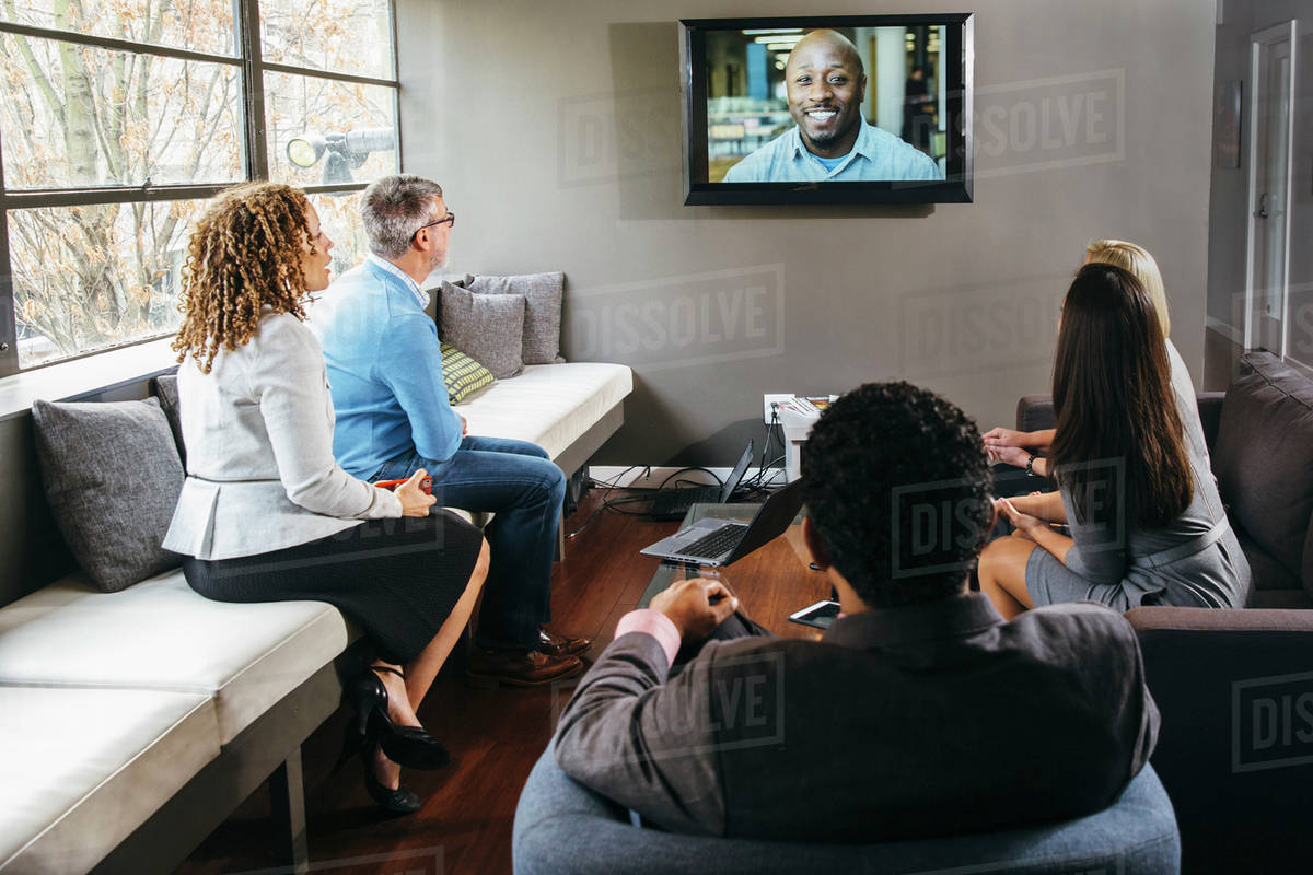 Business people watching teleconference in office meeting - Royalty ...