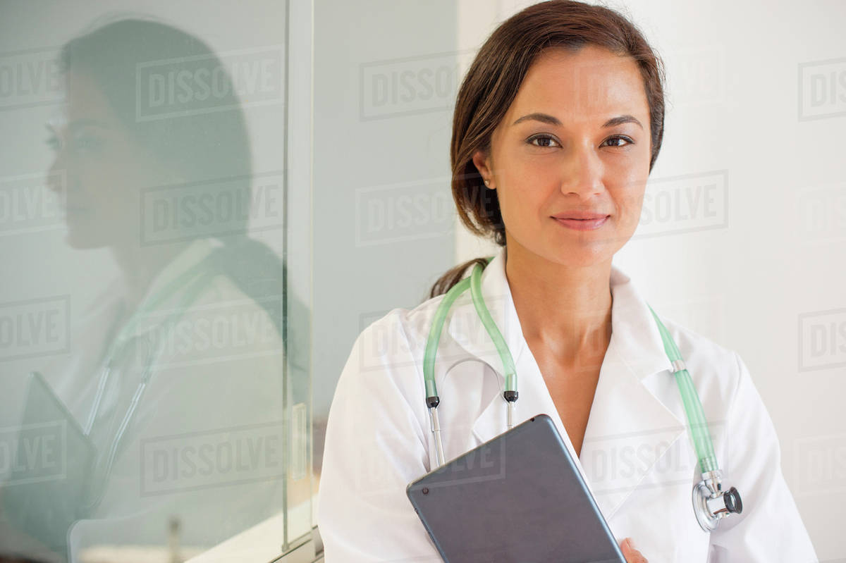Mixed race doctor holding digital tablet - Royalty-free Stock Photo ...