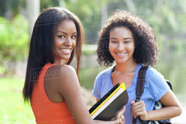 Black students smiling outdoors - Stock Photo - Dissolve