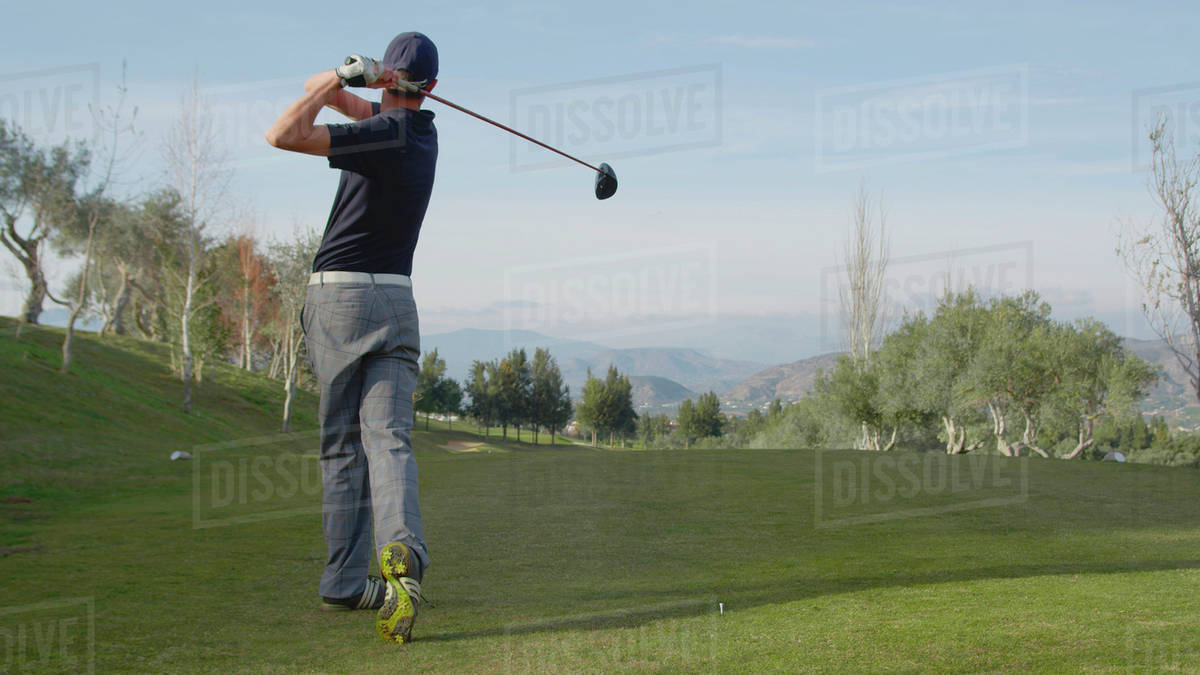 Caucasian man teeing off on golf course - Royalty-free Stock Photo ...