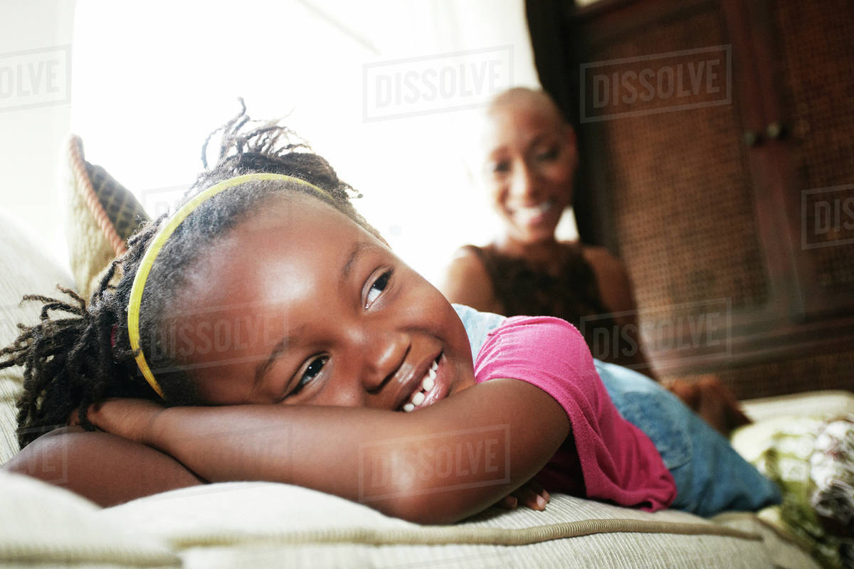 Black girl laying on sofa - Royalty-free Stock Photo | Dissolve