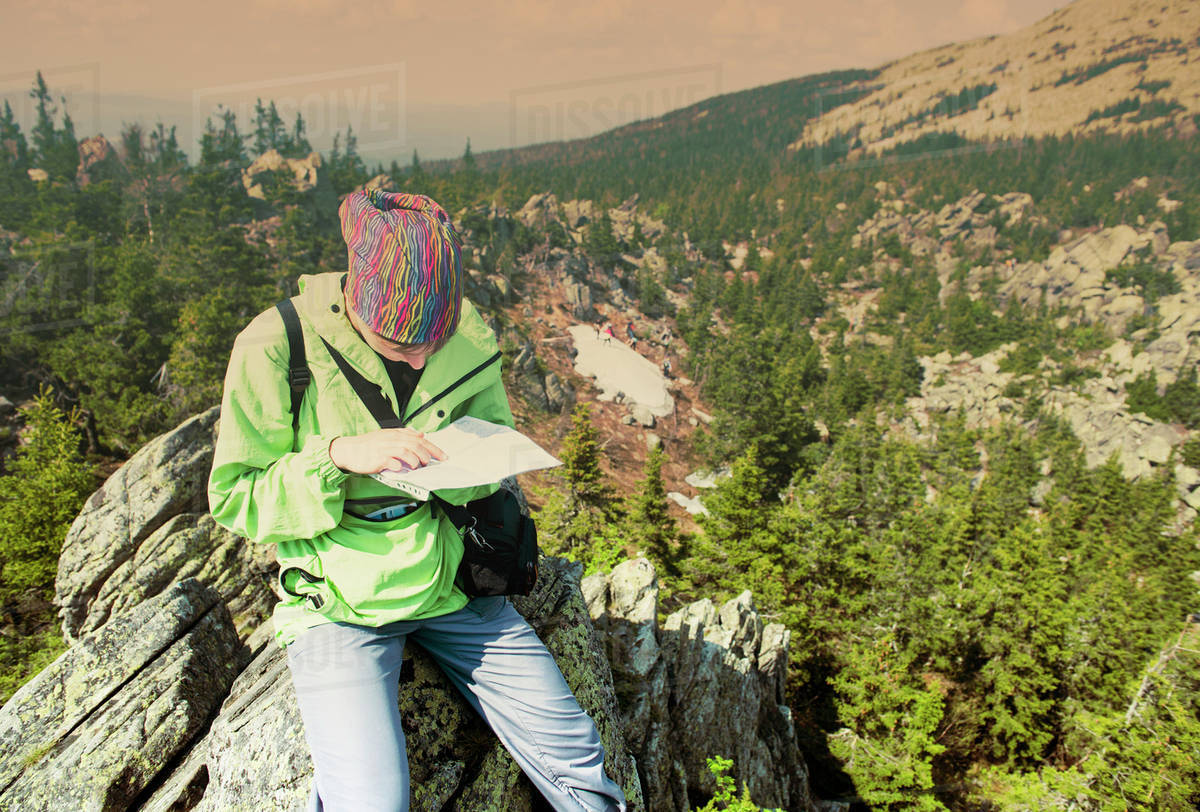 Caucasian hiker reading map on hilltop - Royalty-free Stock Photo ...
