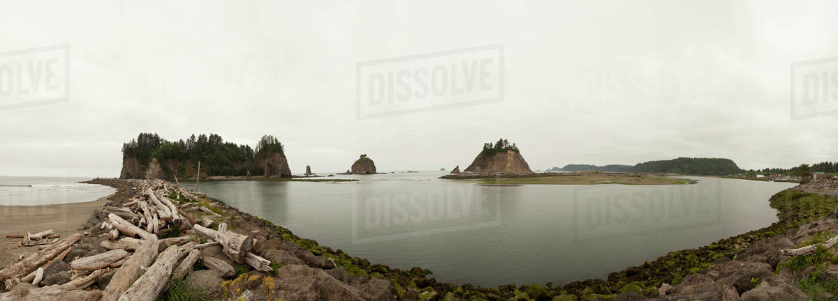Panoramic view of sea stacks on beach - Stock Photo - Dissolve