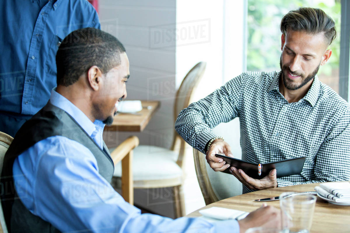 Businessman paying for lunch in cafe - Stock Photo - Dissolve