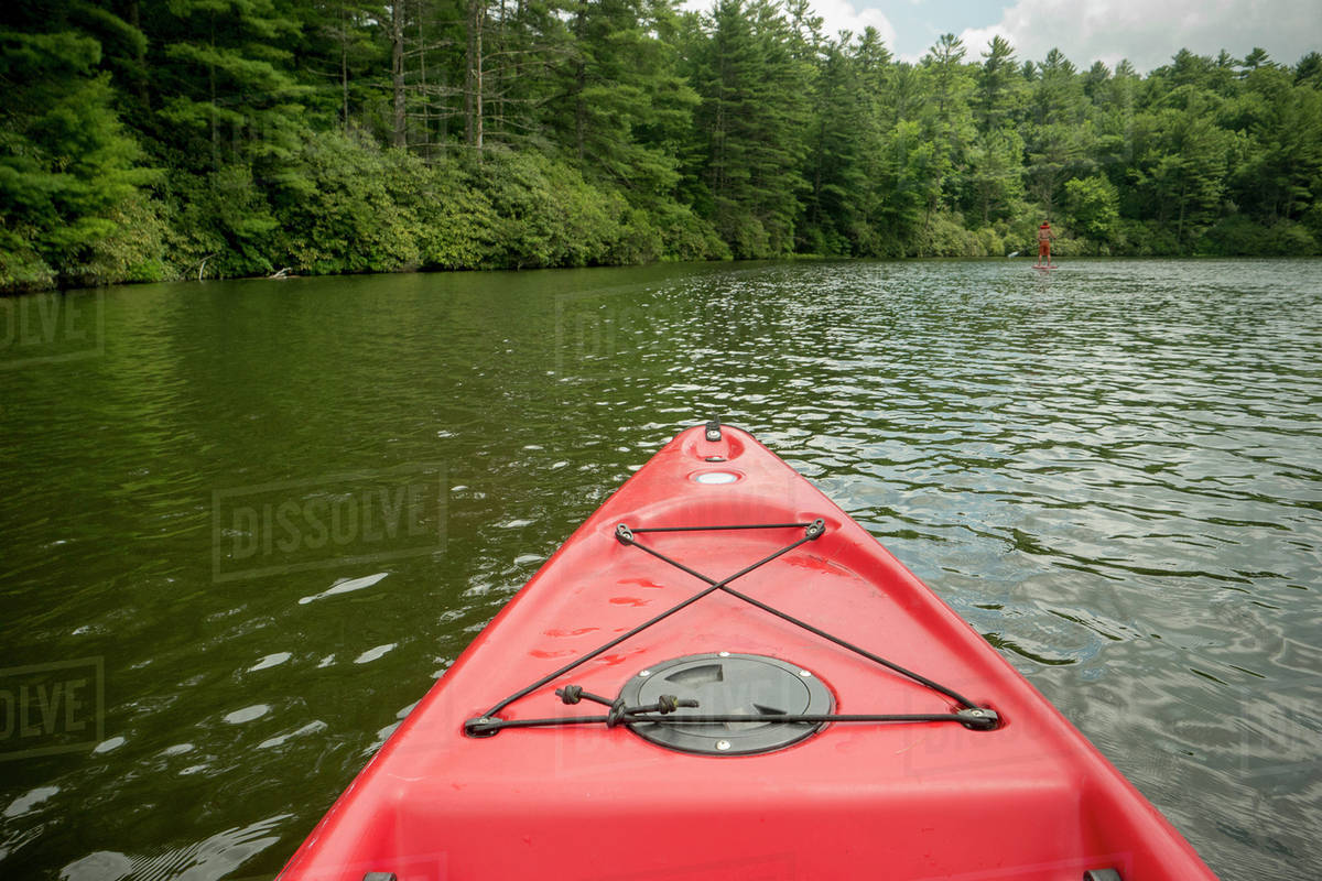 Canoe floating on remote lake - Stock Photo - Dissolve