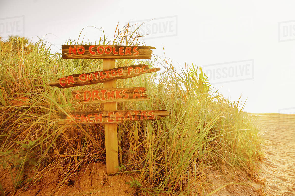 Tourist signs for beach in grass - Stock Photo - Dissolve