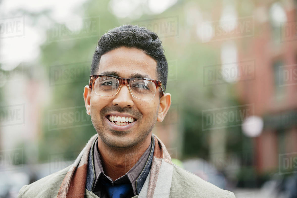 Indian man smiling in city - Stock Photo - Dissolve