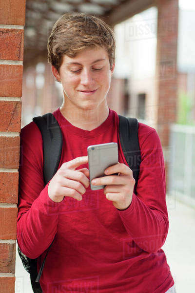 Caucasian teenage boy using cell phone - Royalty-free Stock Photo ...