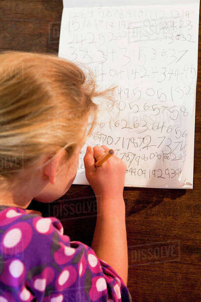 Caucasian girl writing numbers on paper - Royalty-free Stock Photo ...
