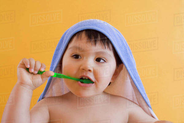 Hispanic boy brushing teeth - Royalty-free Stock Photo | Dissolve