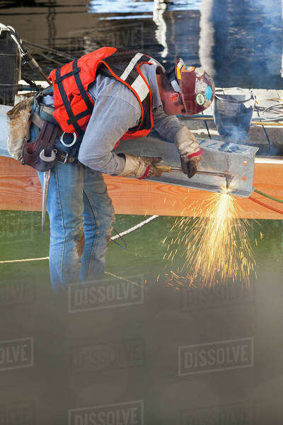 Caucasian worker welding on construction site - Royalty-free Stock ...
