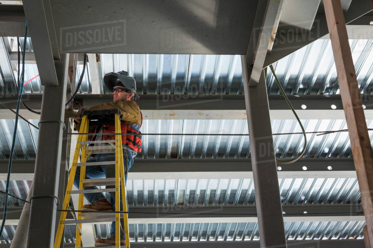 Caucasian construction worker standing on ladder - Royalty-free Stock ...
