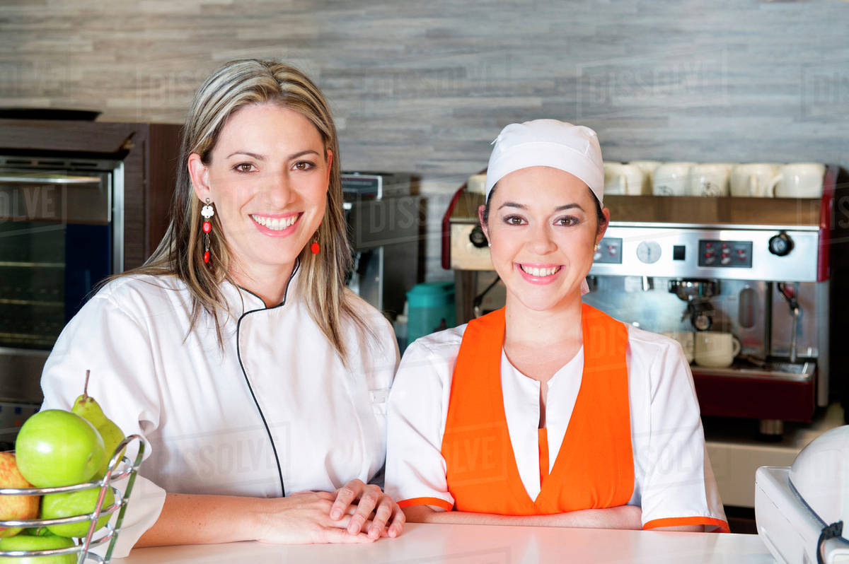 Smiling Hispanic workers in cafe - Stock Photo - Dissolve