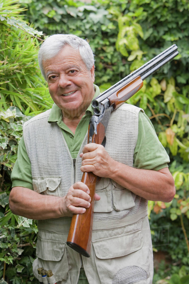 Senior Chilean man holding shotgun - Stock Photo - Dissolve