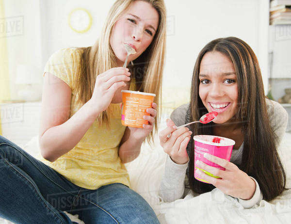 Teenage girls eating ice cream together - Royalty-free Stock Photo ...