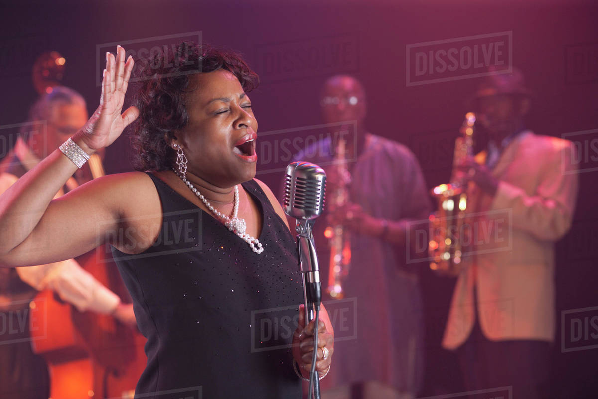 Black woman singing on stage with jazz band - Royalty-free Stock Photo ...