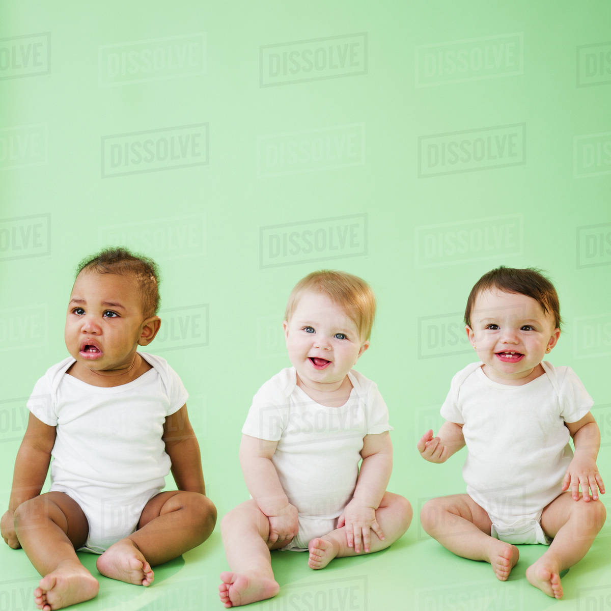 Babies sitting together on floor - Royalty-free Stock Photo | Dissolve