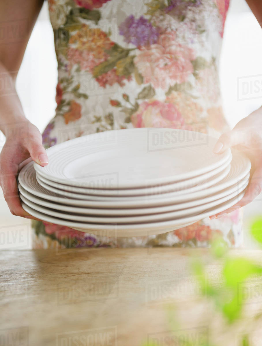 Korean woman carrying plates - Royalty-free Stock Photo | Dissolve