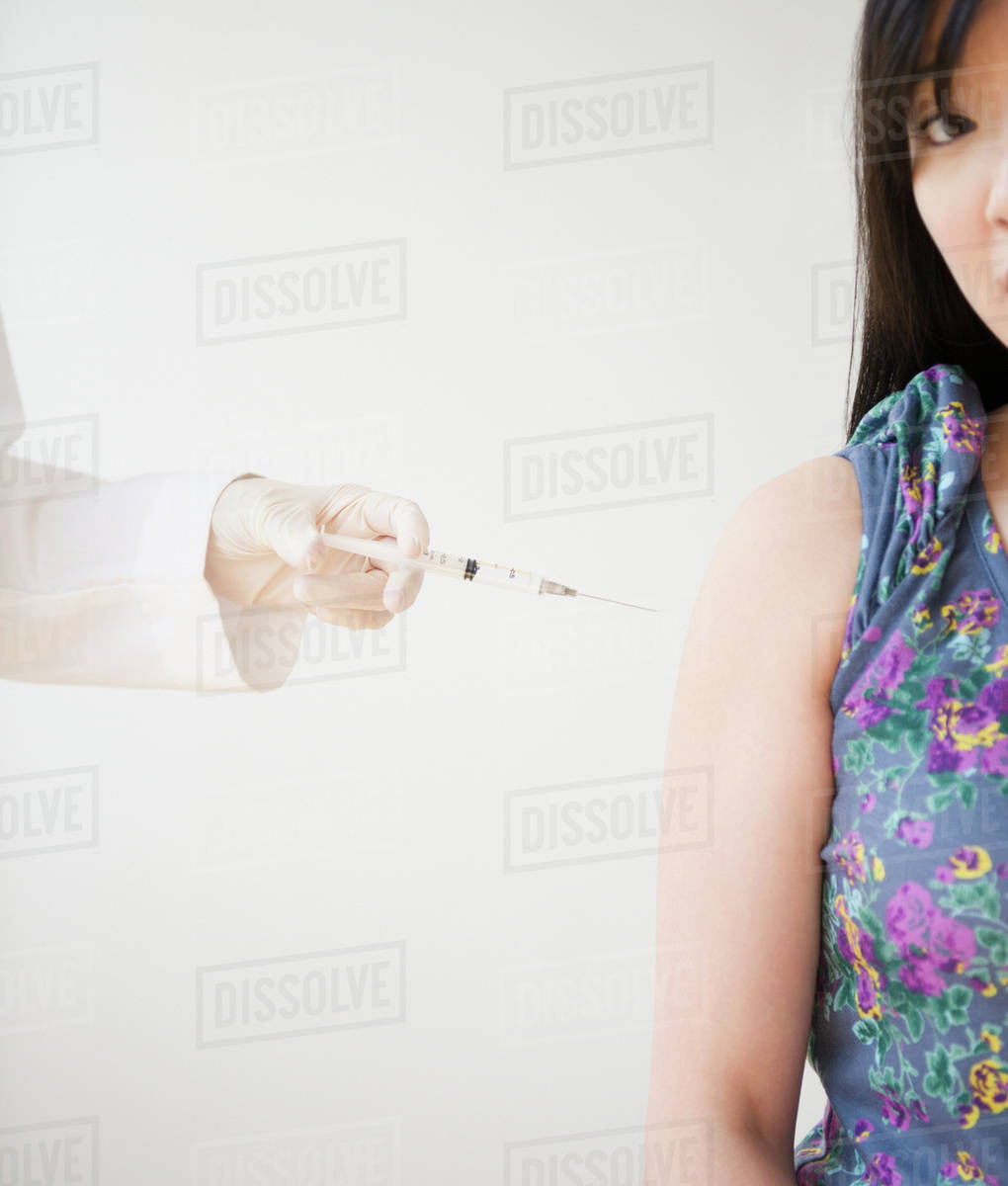 Korean woman receiving injection - Royalty-free Stock Photo | Dissolve