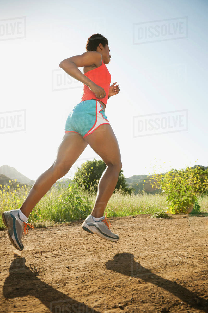 Mixed race woman running on remote trail - Royalty-free Stock Photo ...
