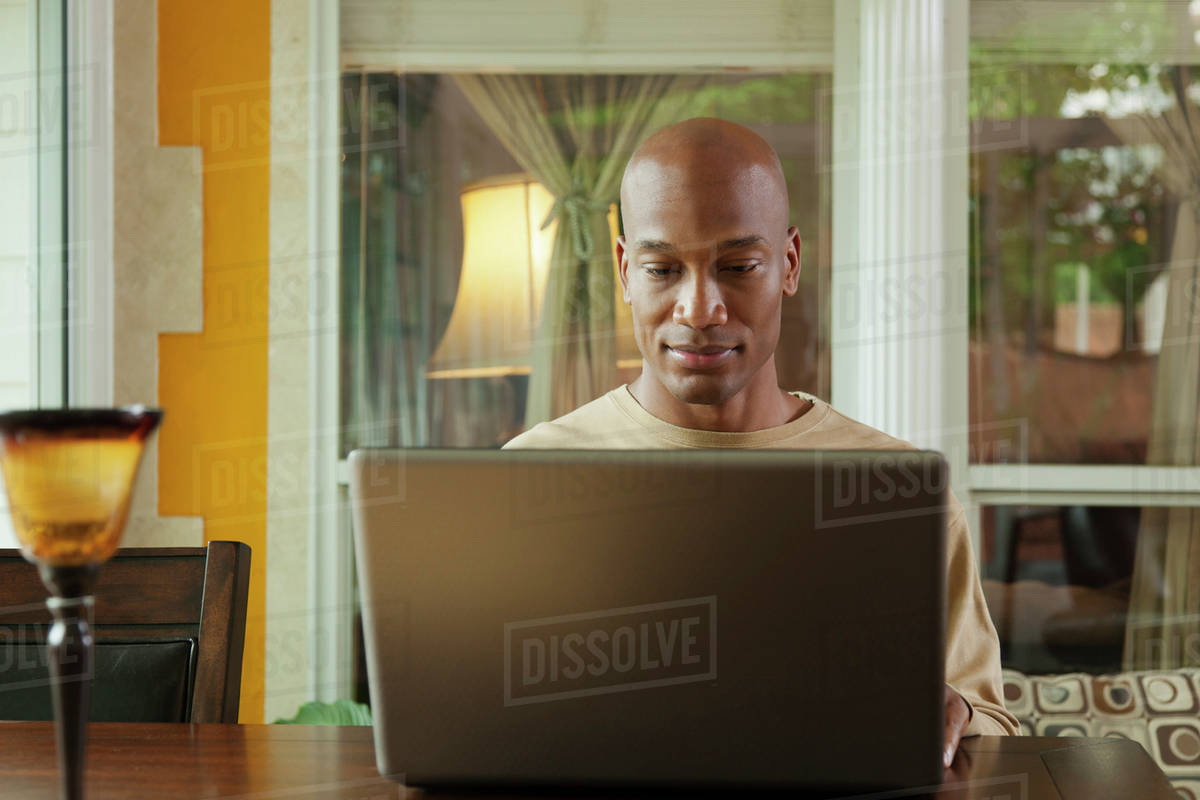 Black man using laptop - Royalty-free Stock Photo | Dissolve