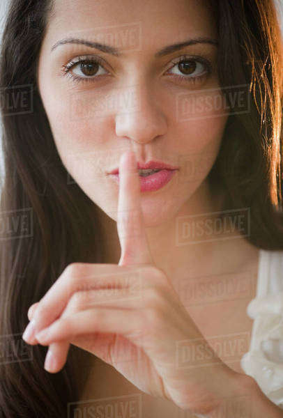 Brazilian woman making shhh gesture - Royalty-free Stock Photo | Dissolve