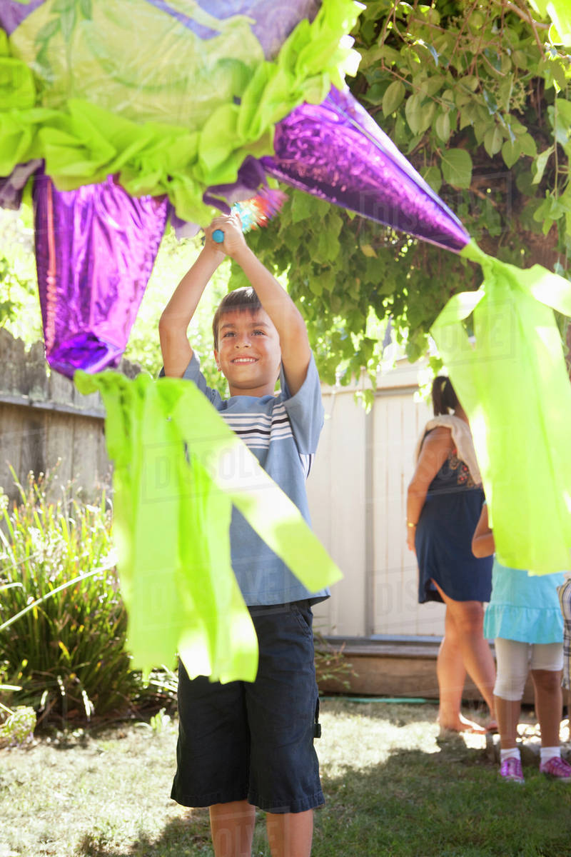 Hispanic boy trying to hit pinata - Royalty-free Stock Photo | Dissolve